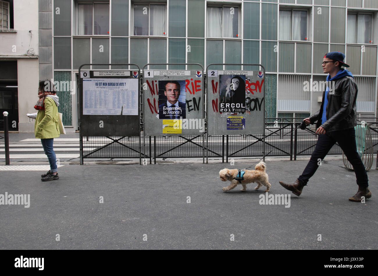 Paris, France. 7th May, 2017. People walking by campaign posters of ...