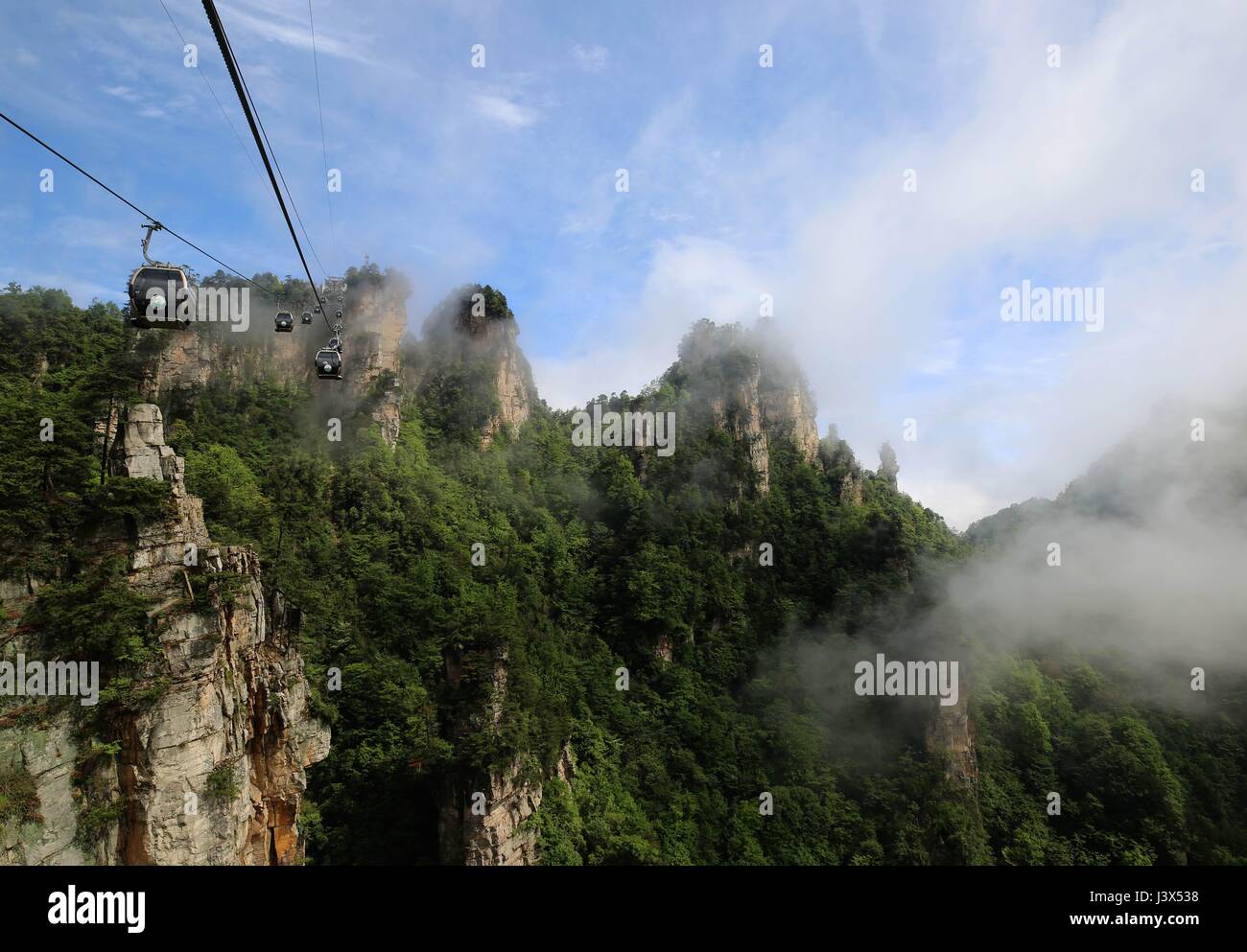 Zhangjiajie, China's Hunan Province. 8th May, 2017. Tourists take cable ...