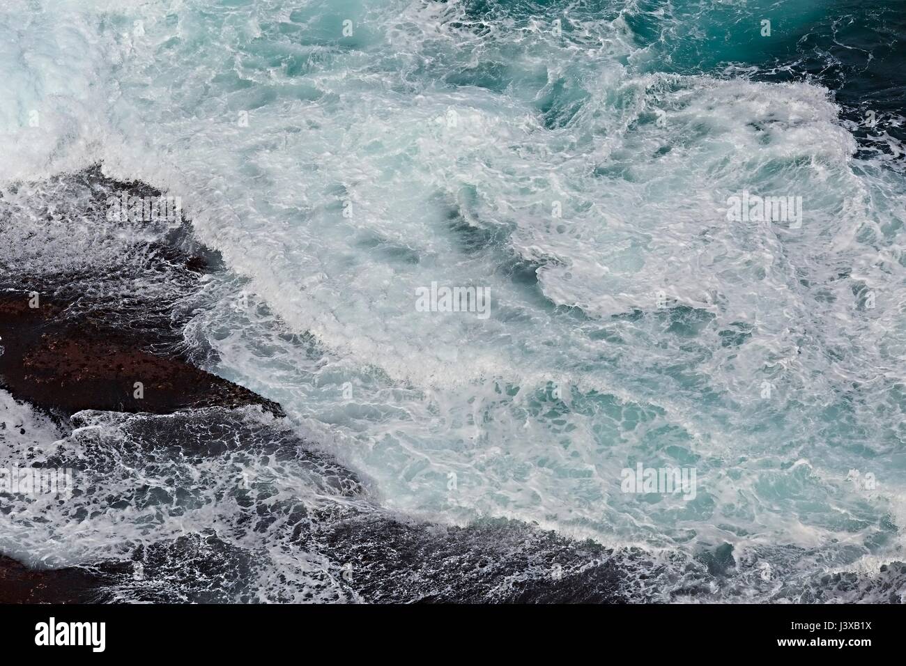 Waves hitting the sea shore cliffs Stock Photo - Alamy