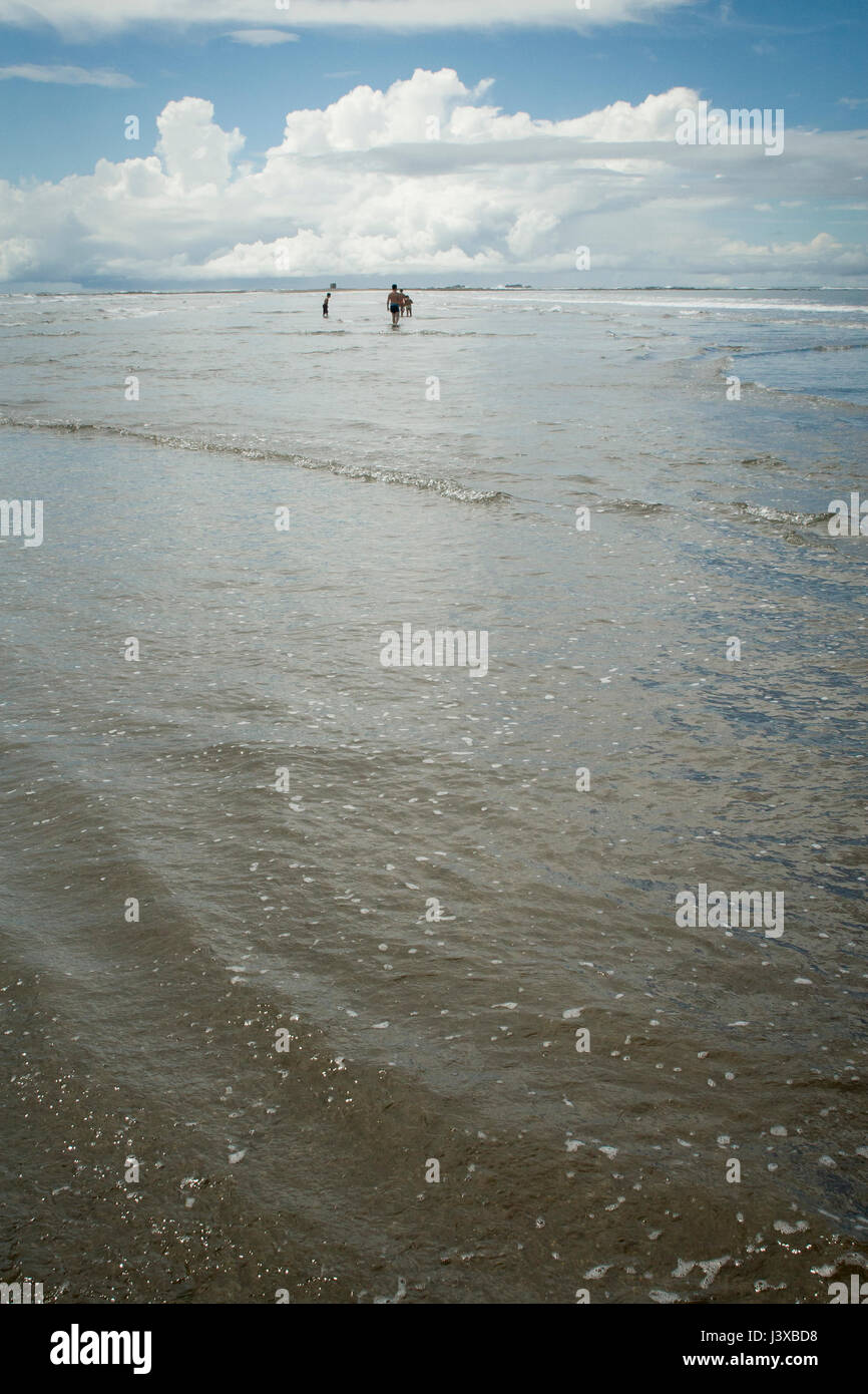 Swimmers wade far out into the gently-sloping beach Stock Photo - Alamy