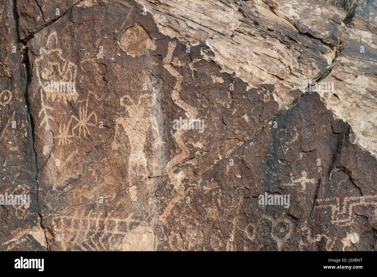 Petroglyphs (including an anthropomorphic figure with horns and a snake ...