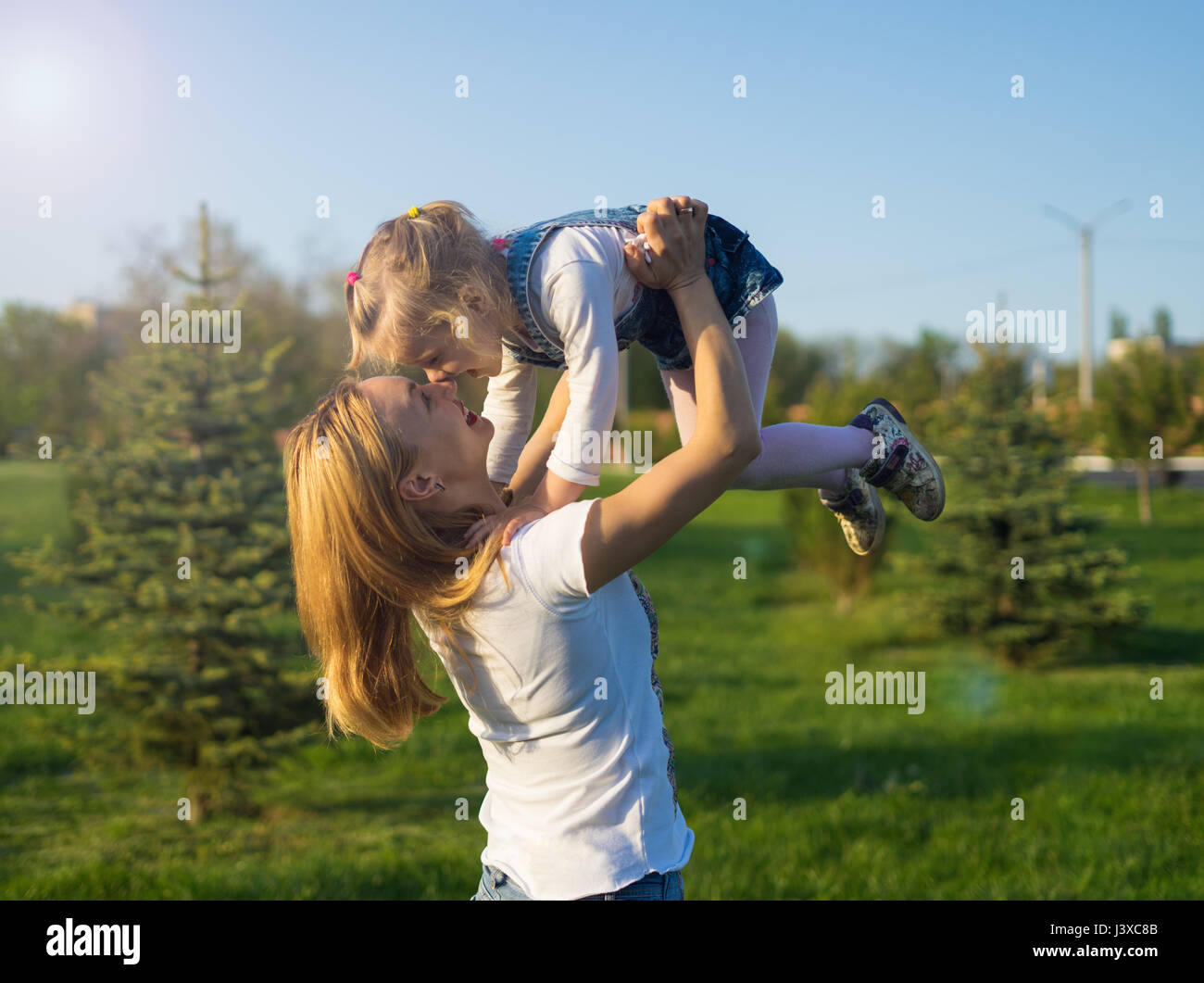 Mother lifting up her child hi-res stock photography and images - Alamy