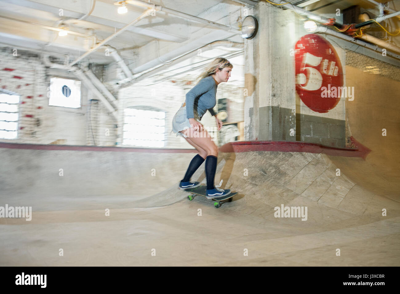 Young woman skateboarding Stock Photo - Alamy