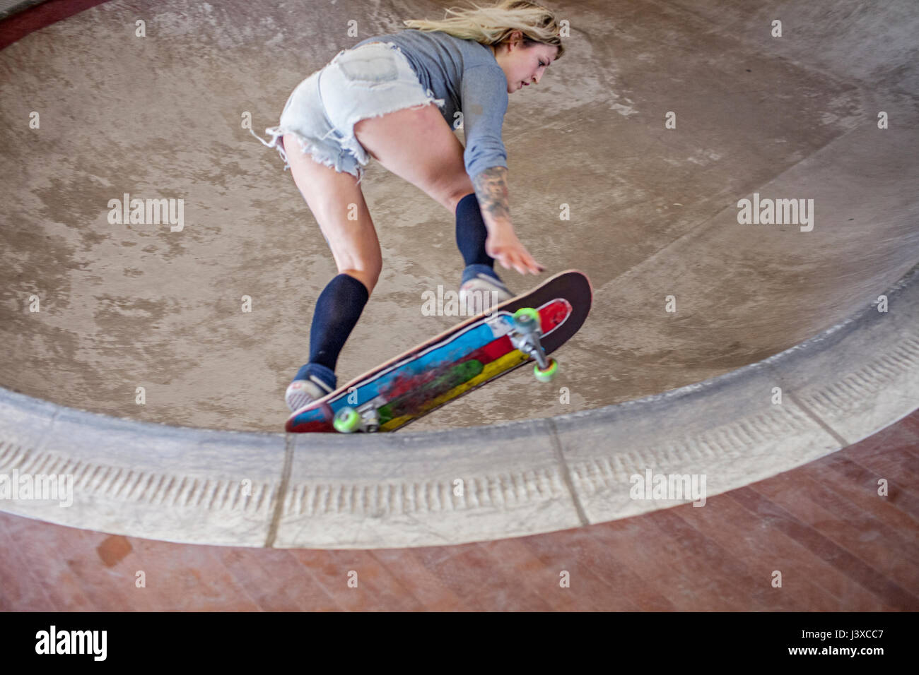 Young woman skateboarding Stock Photo - Alamy