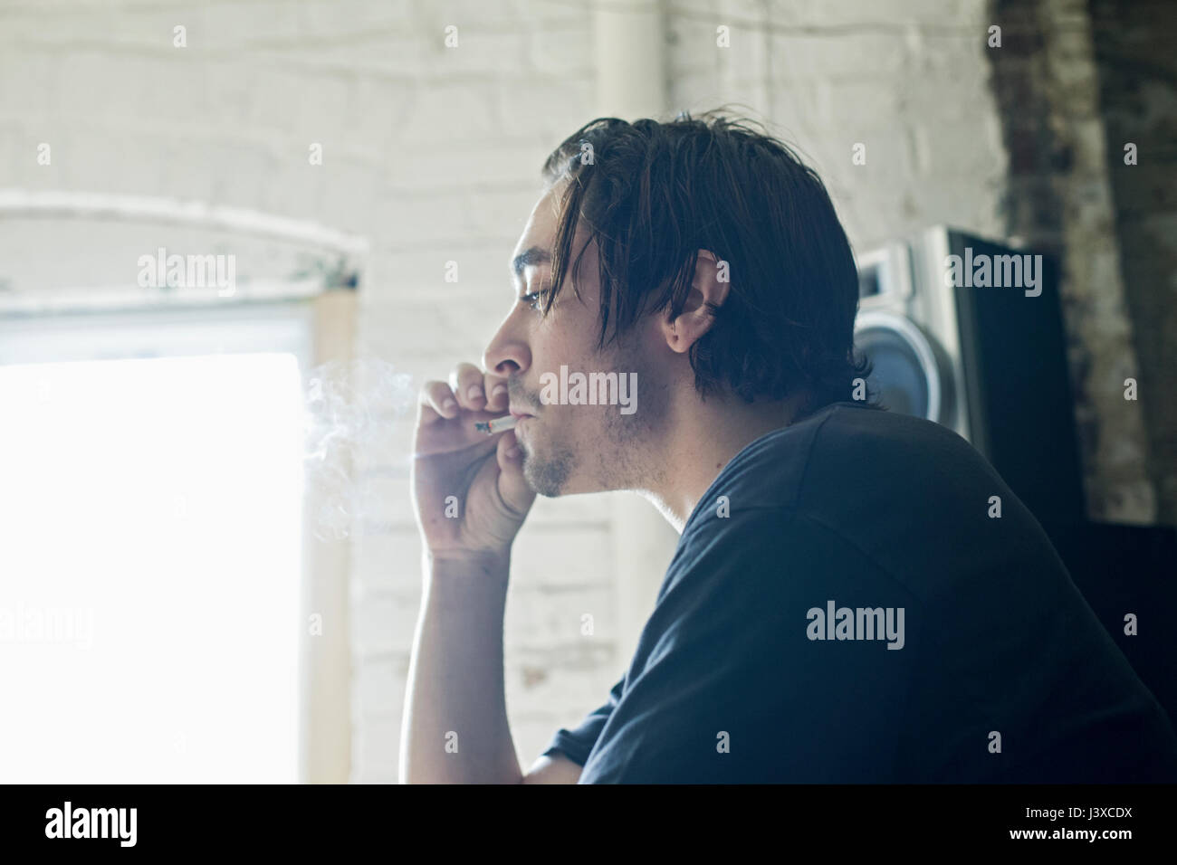Profile of a young man smoking Stock Photo - Alamy