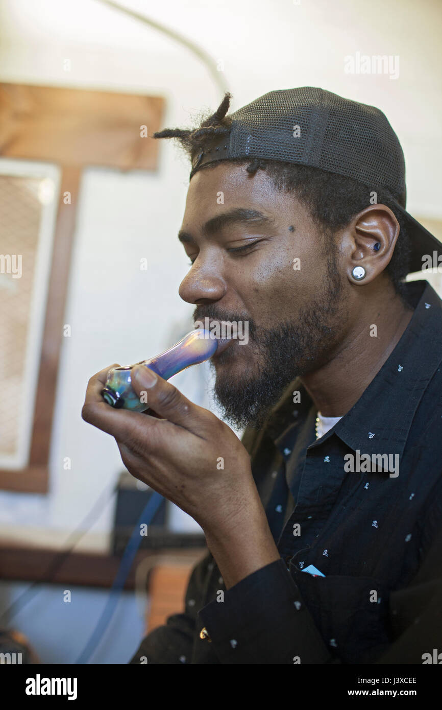 Portrait of a young man smoking Stock Photo - Alamy