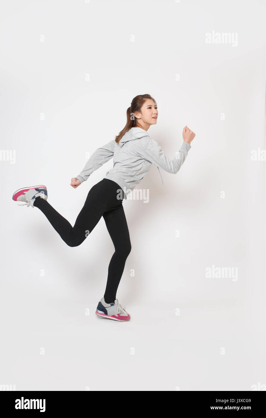 Side view of active sporty young running woman runner Stock Photo - Alamy