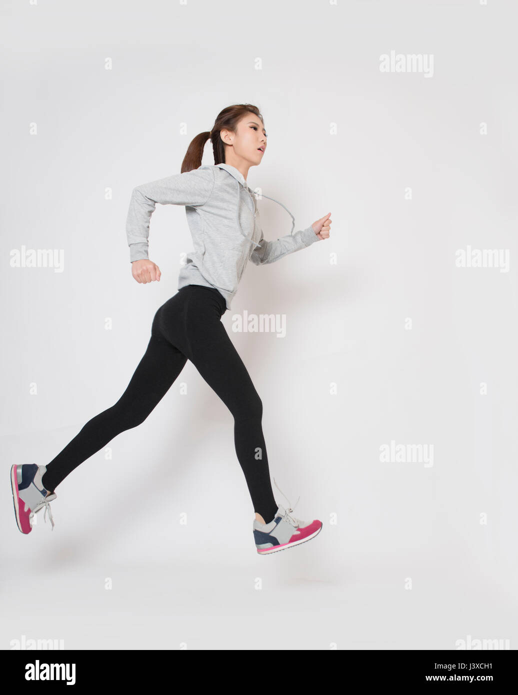 Side view of active sporty young running woman runner Stock Photo - Alamy