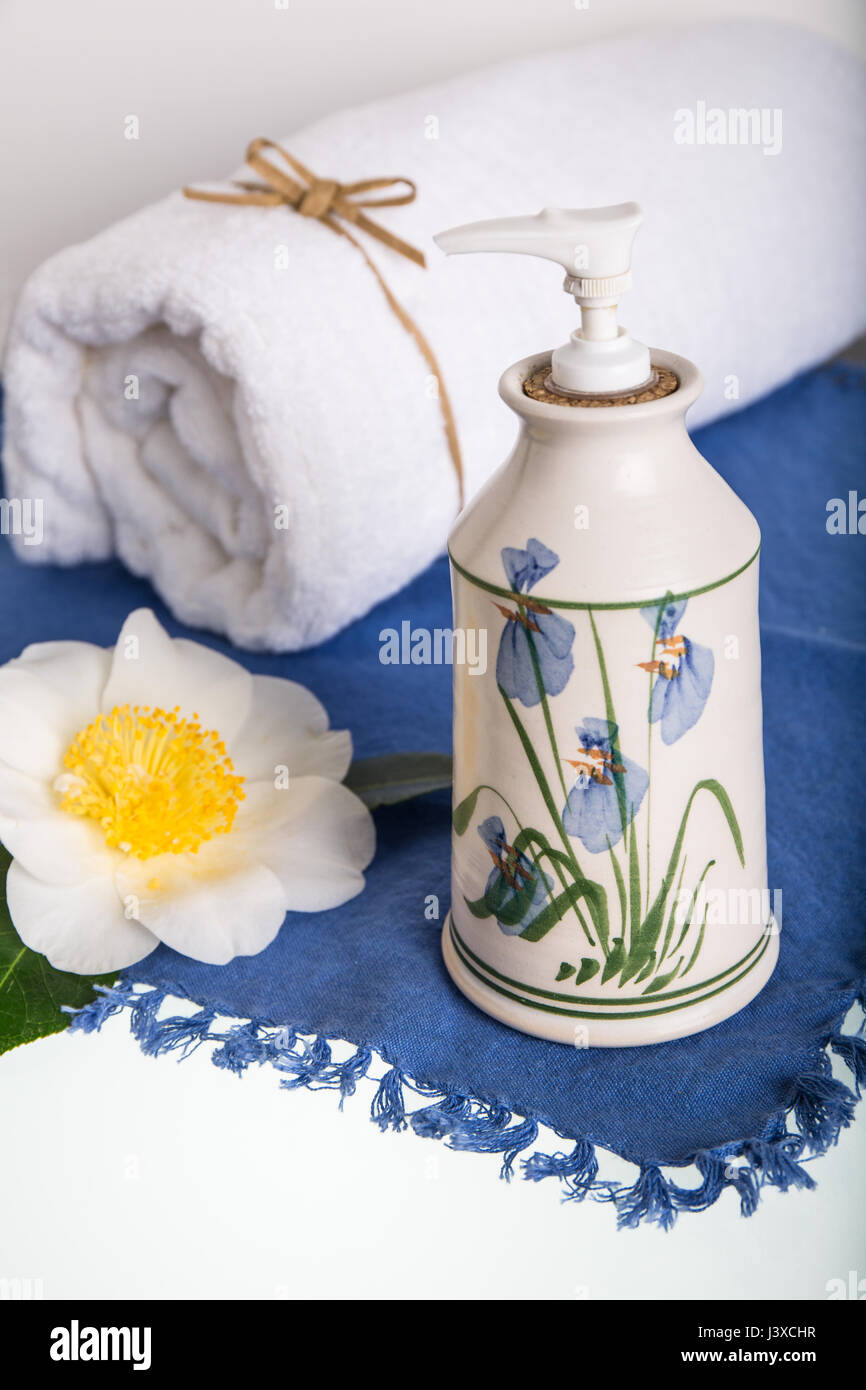 Lotion in an attractive pottery container, surrounded by a White Rugosa ...