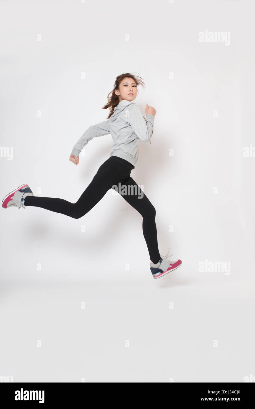 Side view of active sporty young running woman runner Stock Photo - Alamy