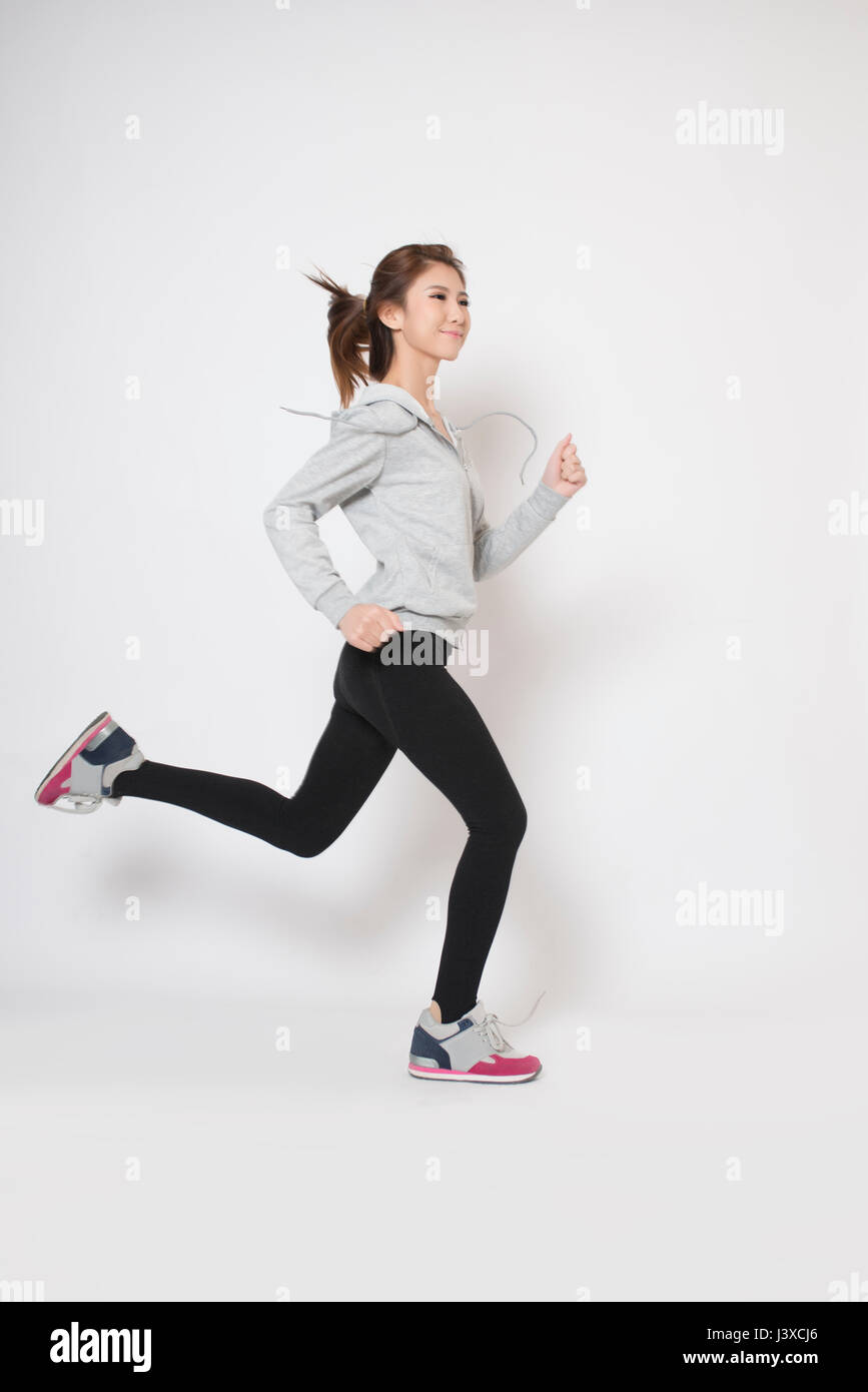 Side view of active sporty young running woman runner Stock Photo - Alamy