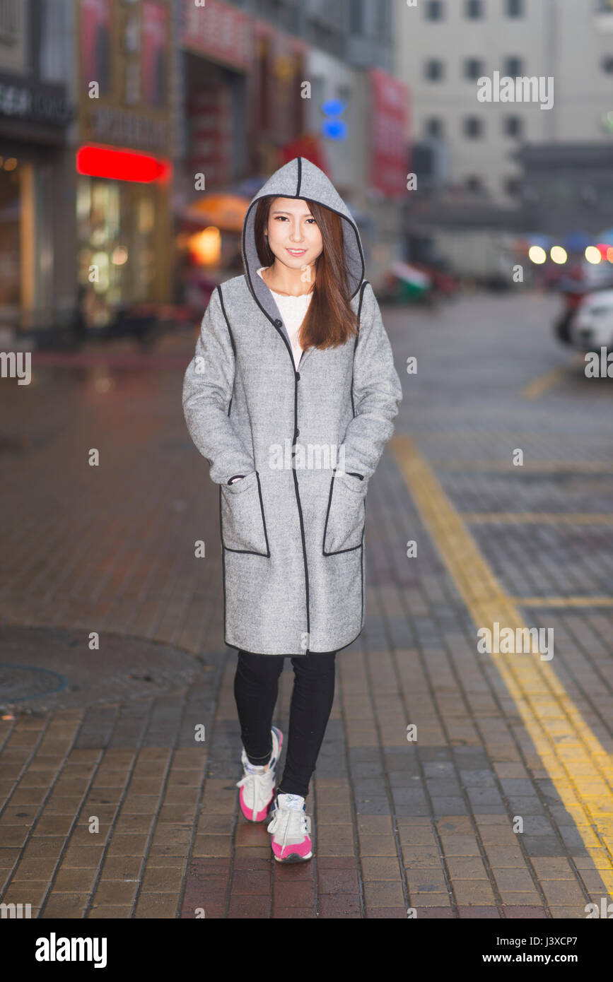 Happy lady walking in the night street Stock Photo - Alamy