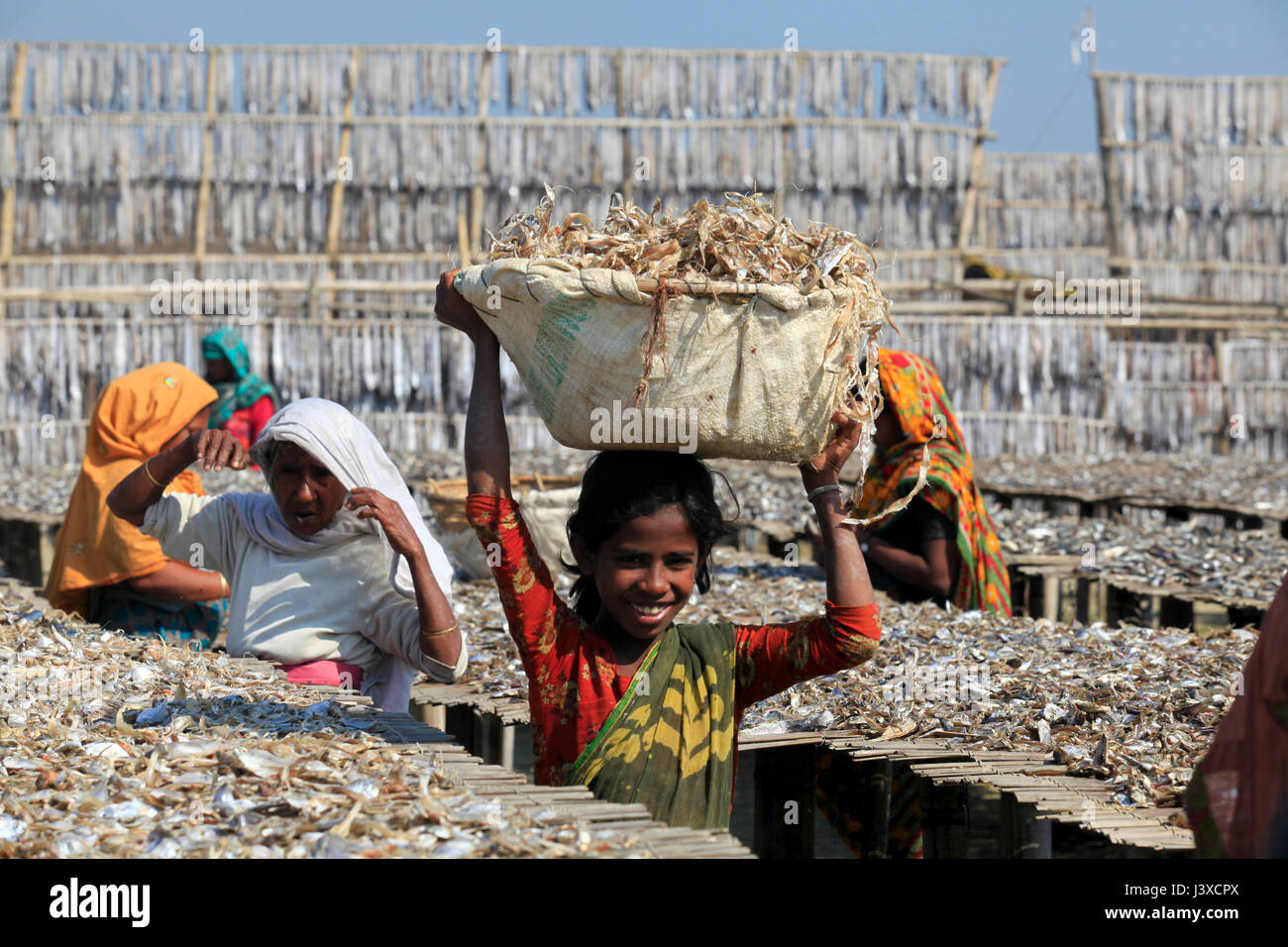 Workers processing fish to be dried at Nazirartek Dry Fish Plant in Cox ...