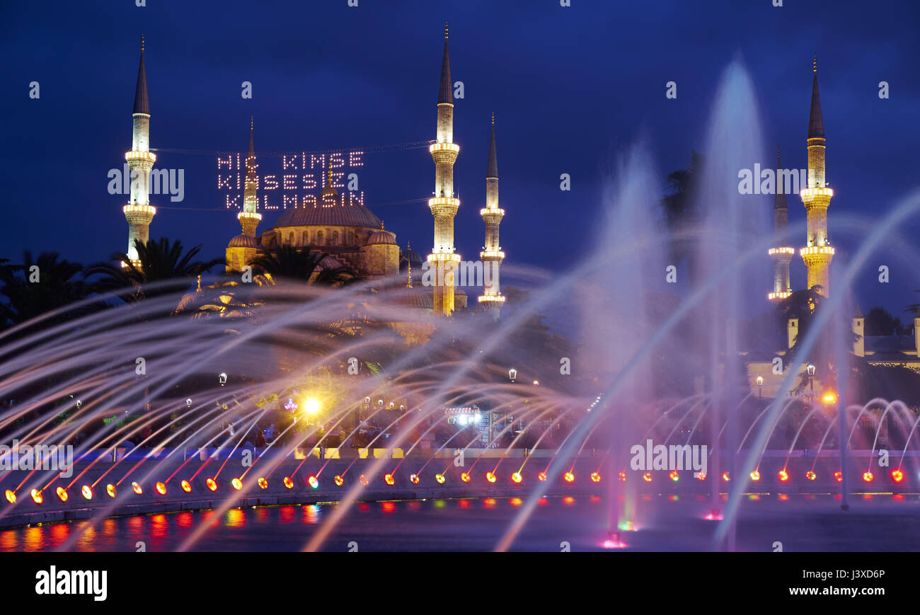 The view of Blue mosque throught the fountain water in the evening ...