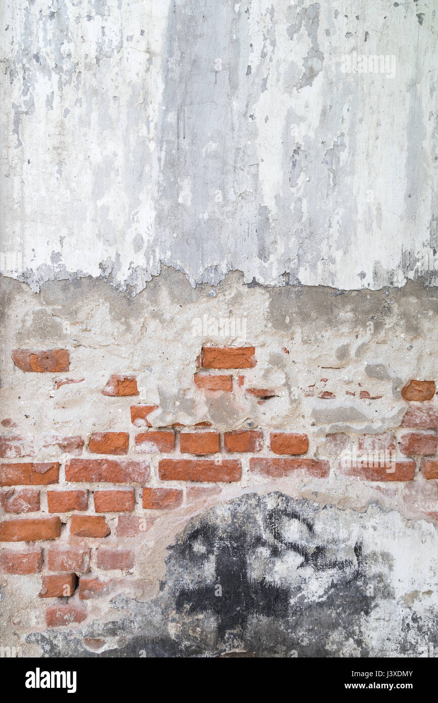 Broken, old and plastered wall revealing old brick wall Stock Photo - Alamy
