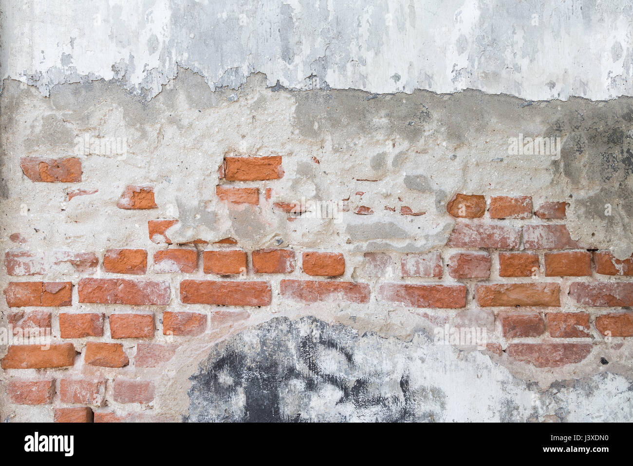 Broken, old and plastered wall revealing old brick wall Stock Photo - Alamy