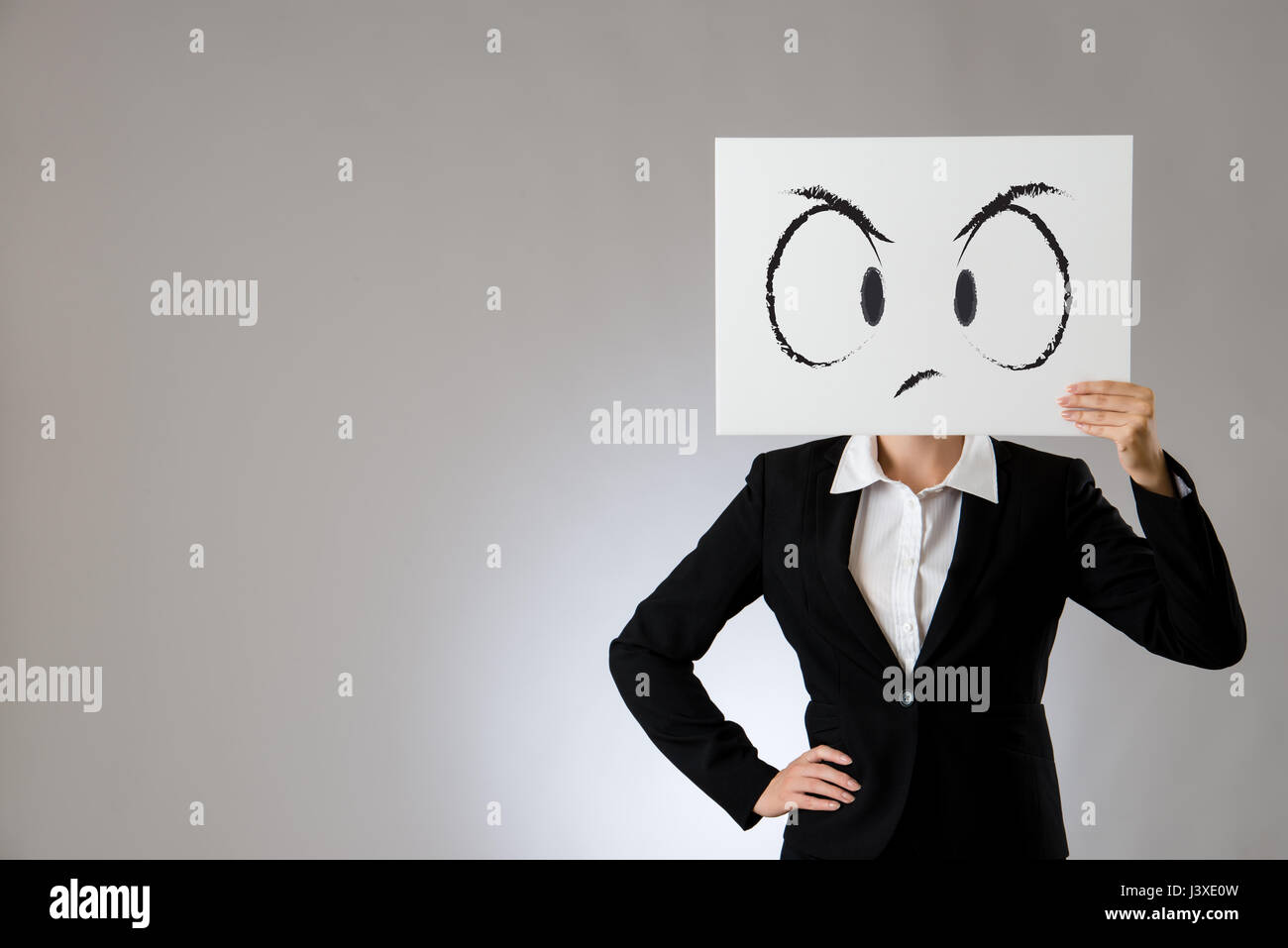 angry boss face drawing on blank billboard holding by business woman ...