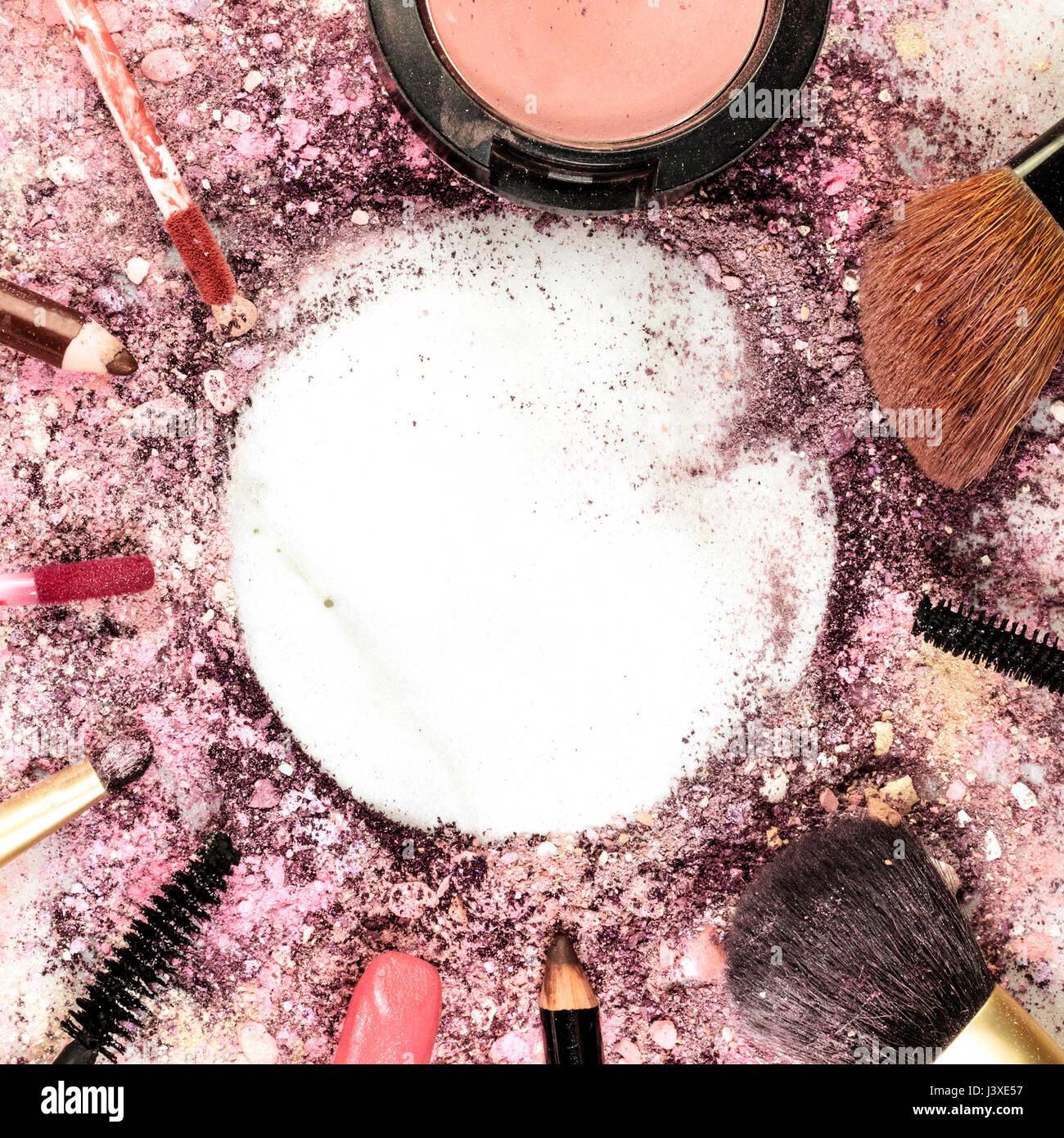 Makeup brushes, pencil, lipstick and other objects, forming a frame on ...