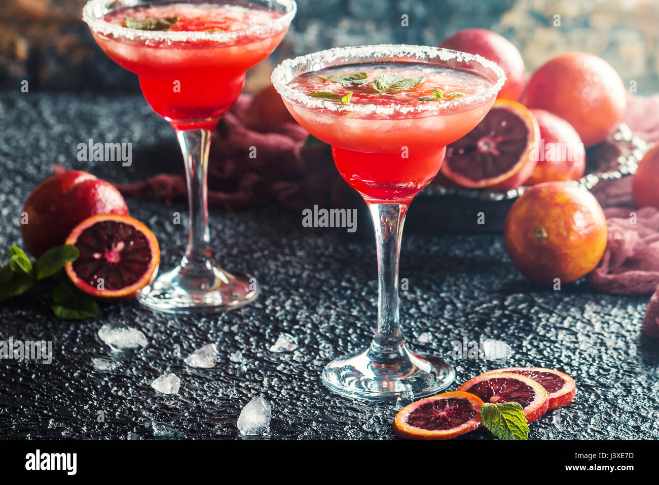 Blood Orange Margarita cocktail with mint and red orange in salt rimmed ...