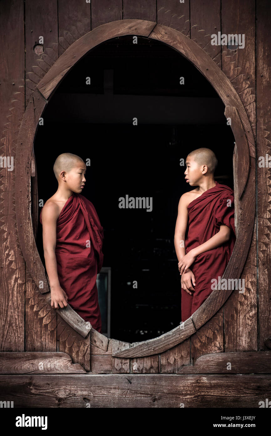Myanmar Two monks at a big window of their monastery Stock Photo - Alamy