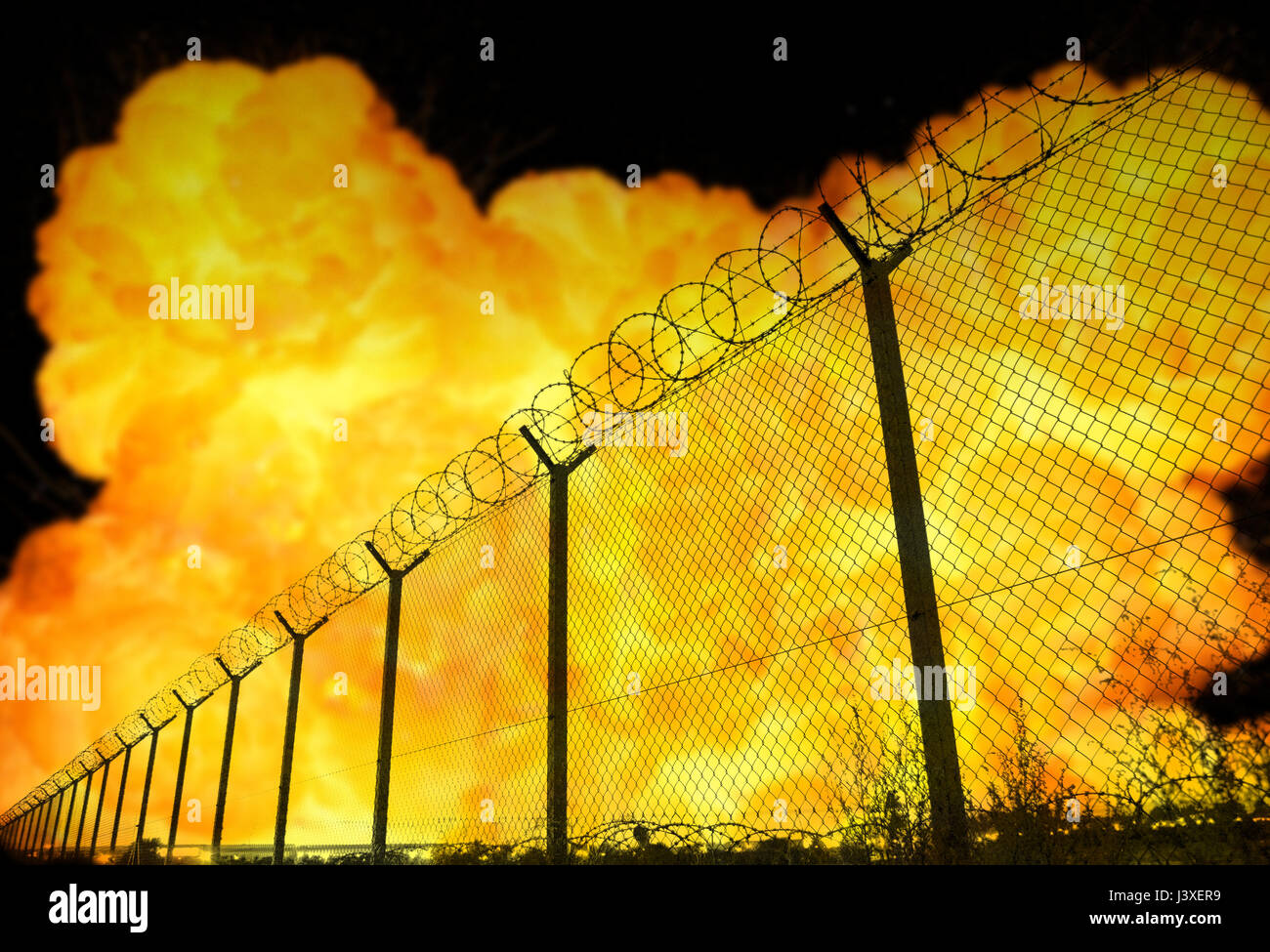 Realistic orange fire explosion behind restricted area barbed wire ...