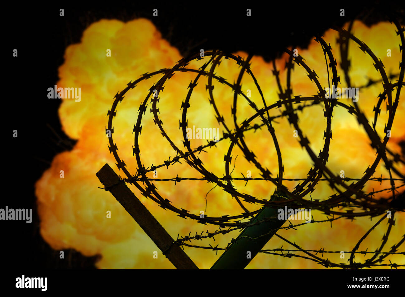 Realistic orange fire explosion behind restricted area barbed wire ...