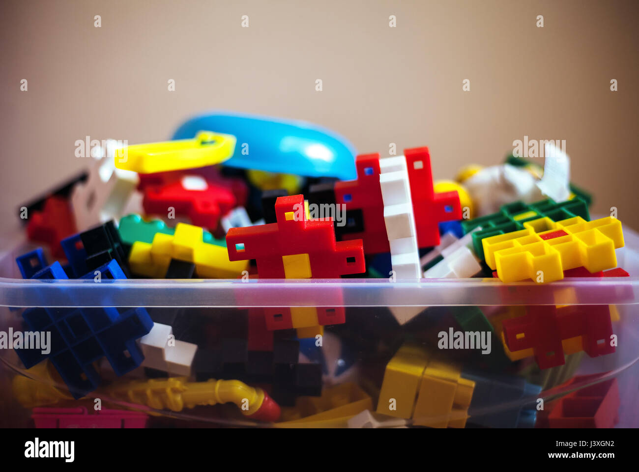 Closeup of various colorful puzzles in plastic container Stock Photo ...