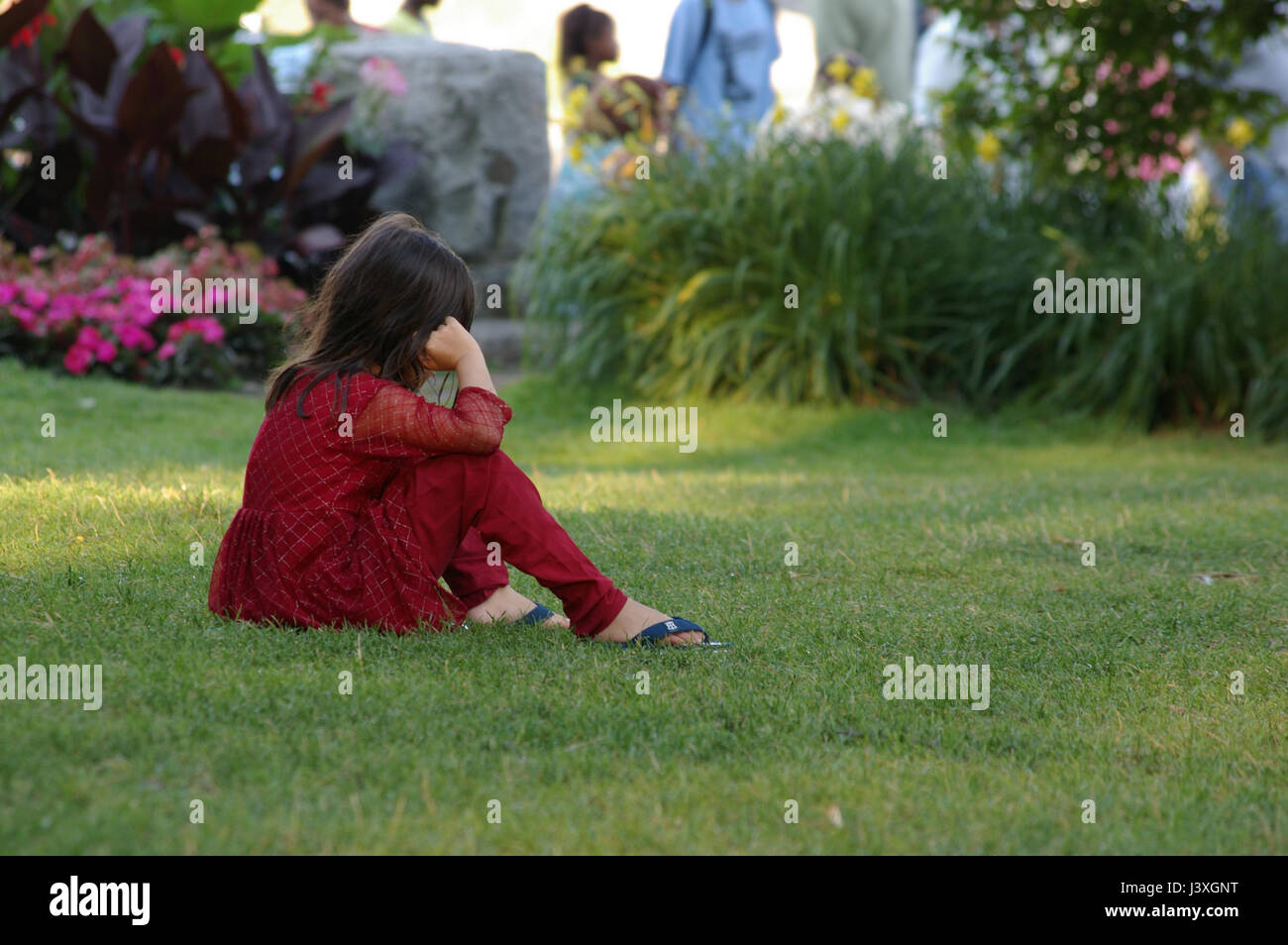 Child sat alone looking sad Stock Photo - Alamy
