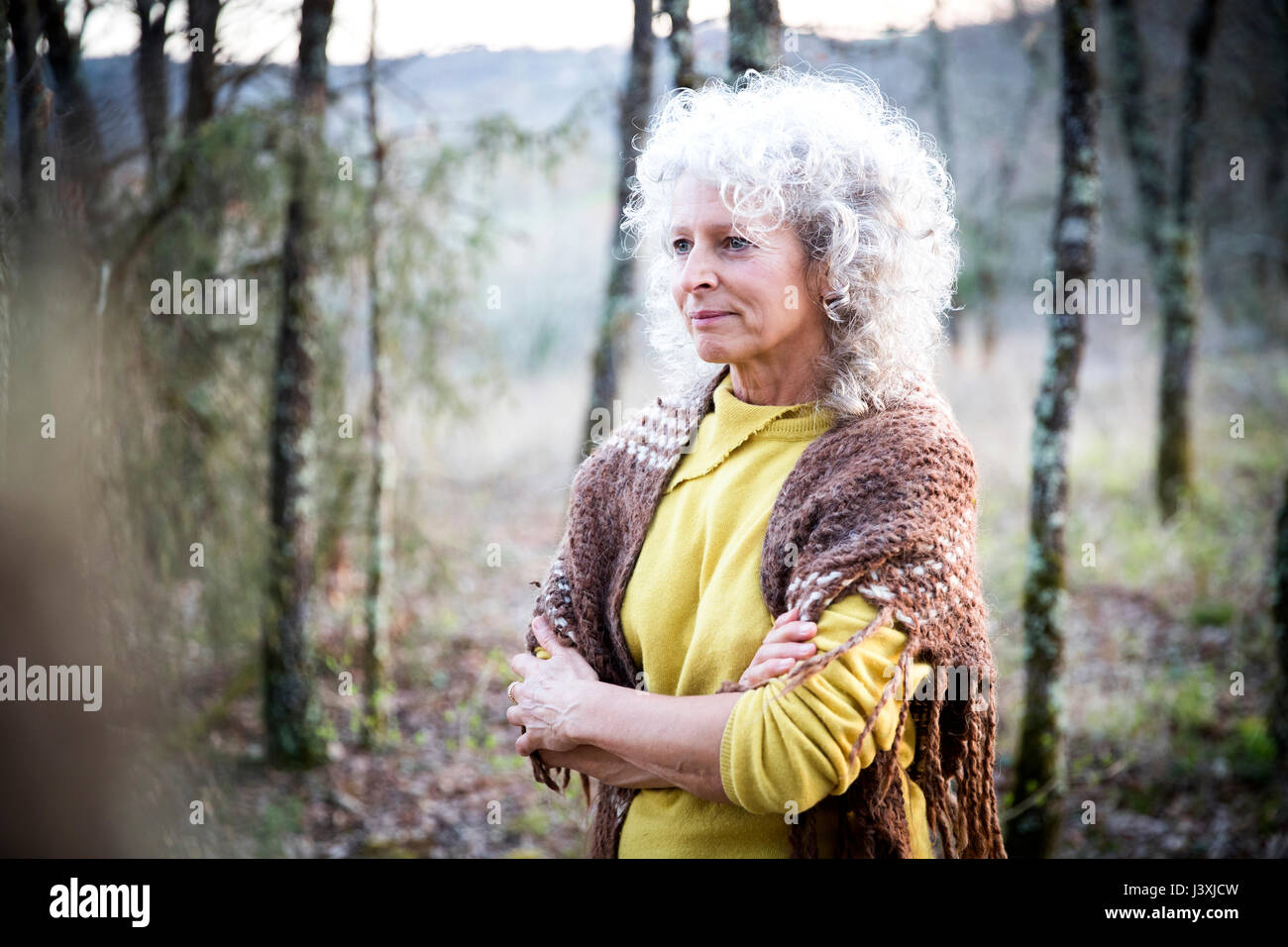 Mature woman standing in woodland with arms folded Stock Photo - Alamy Mature woman standing in woodland with arms folded Stock Photo - Alamy