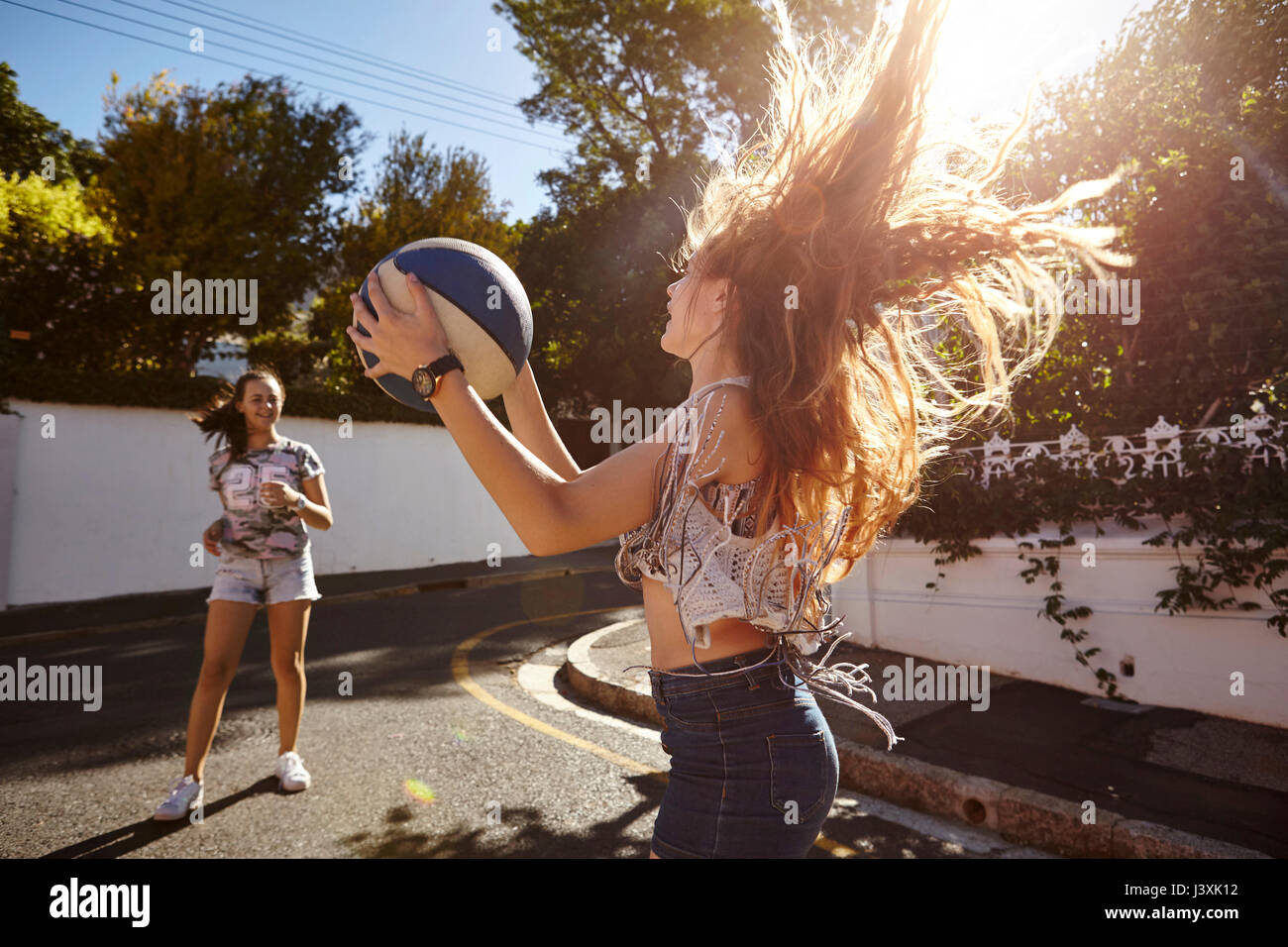 Teenage girls playing with ball in street, Cape Town, South Africa ...