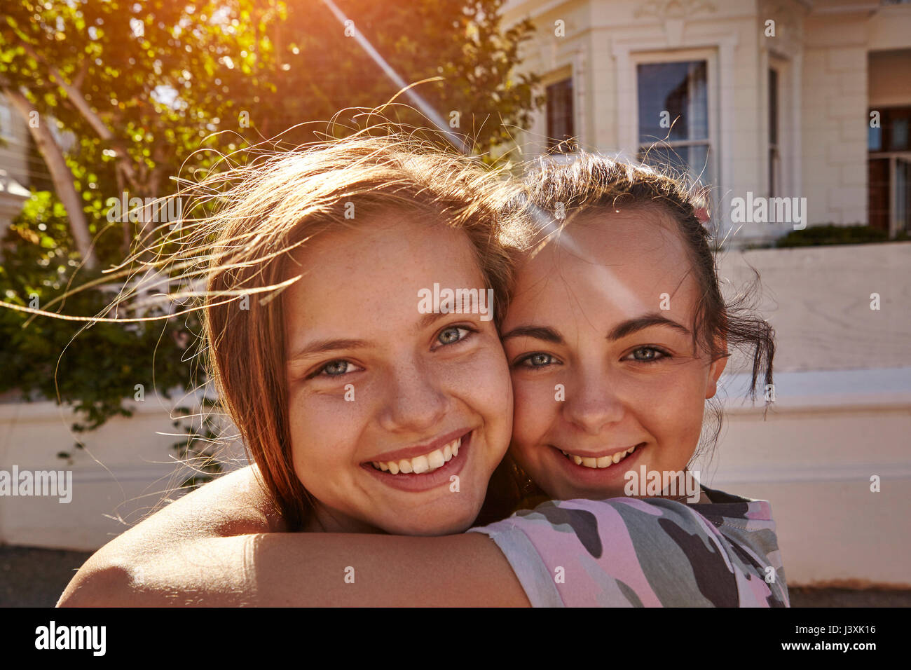 Teenage girls having fun in residential street, Cape Town, South Africa ...