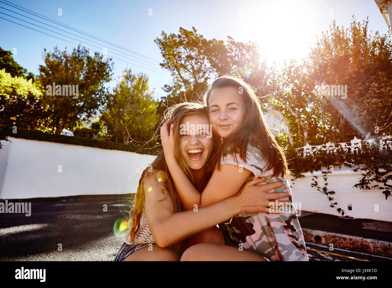 Teenage girls having fun in residential street, Cape Town, South Africa ...