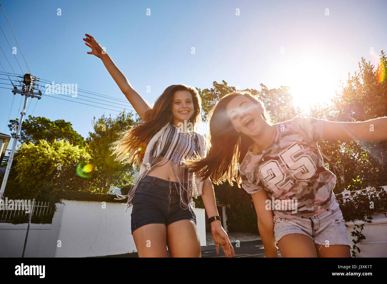 Teenage girls having fun in residential street, Cape Town, South Africa ...