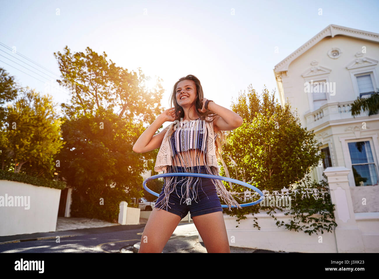 Teenage girl with hoola hoop in street, Cape Town, South Africa Stock ...