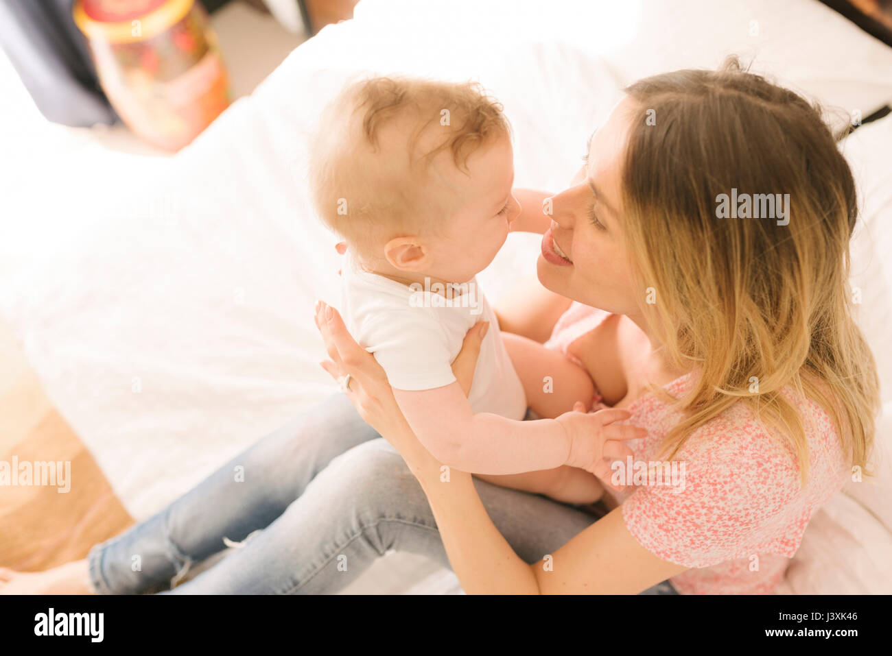 Mother and baby bonding on bed Stock Photo - Alamy