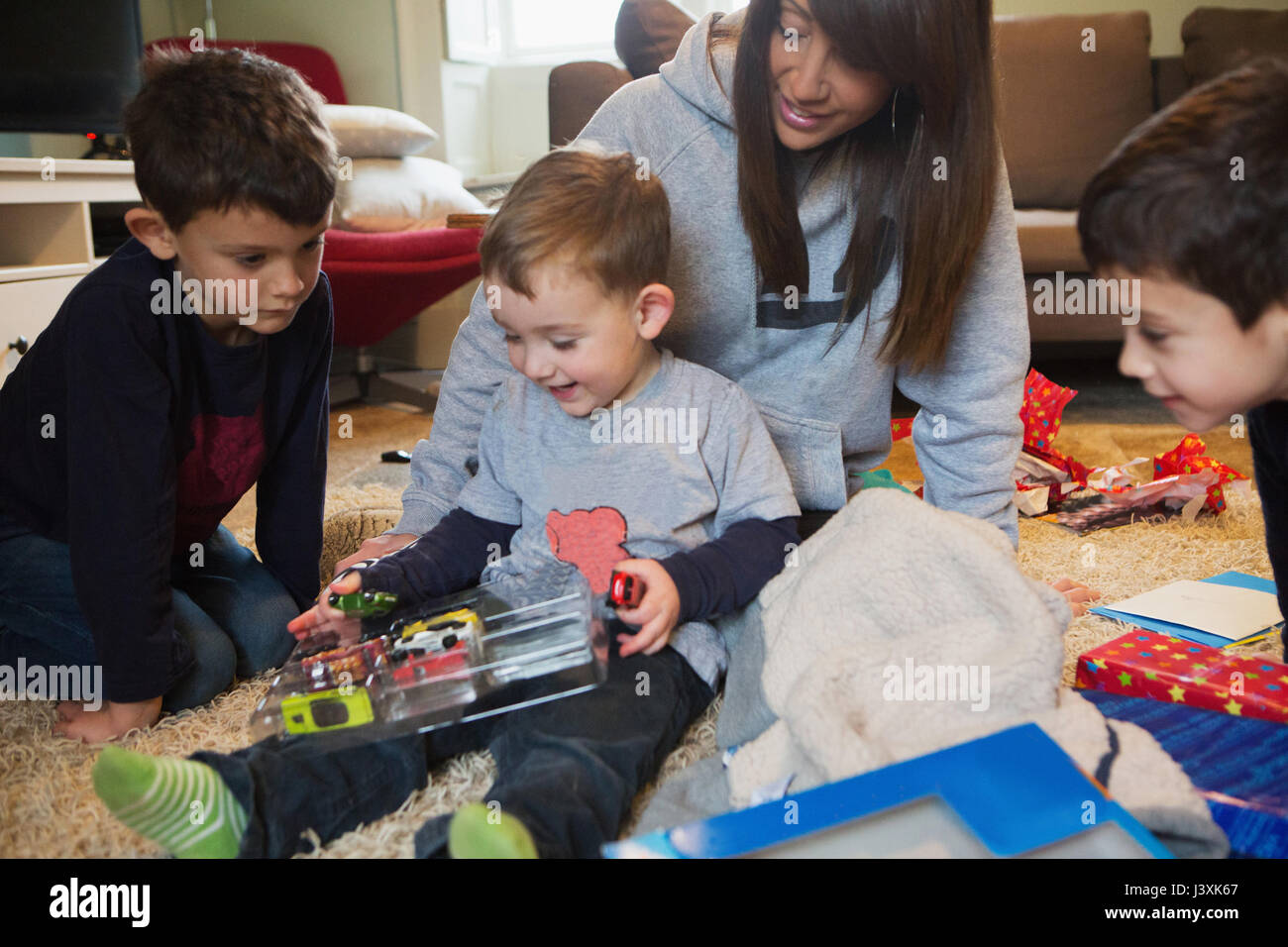Mother watching over son and friends at birthday party Stock Photo - Alamy