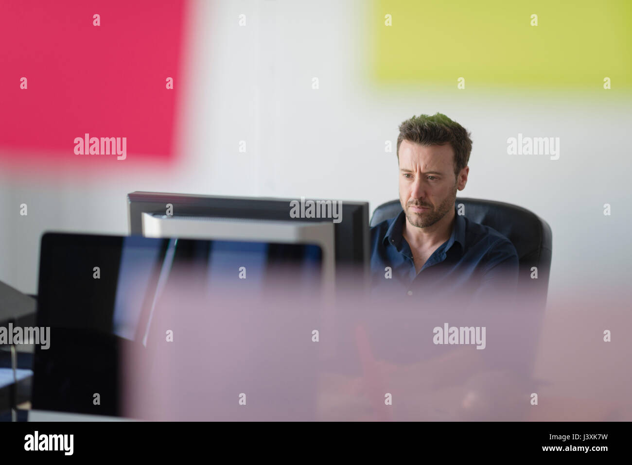 Man working at computer on office desk Stock Photo - Alamy