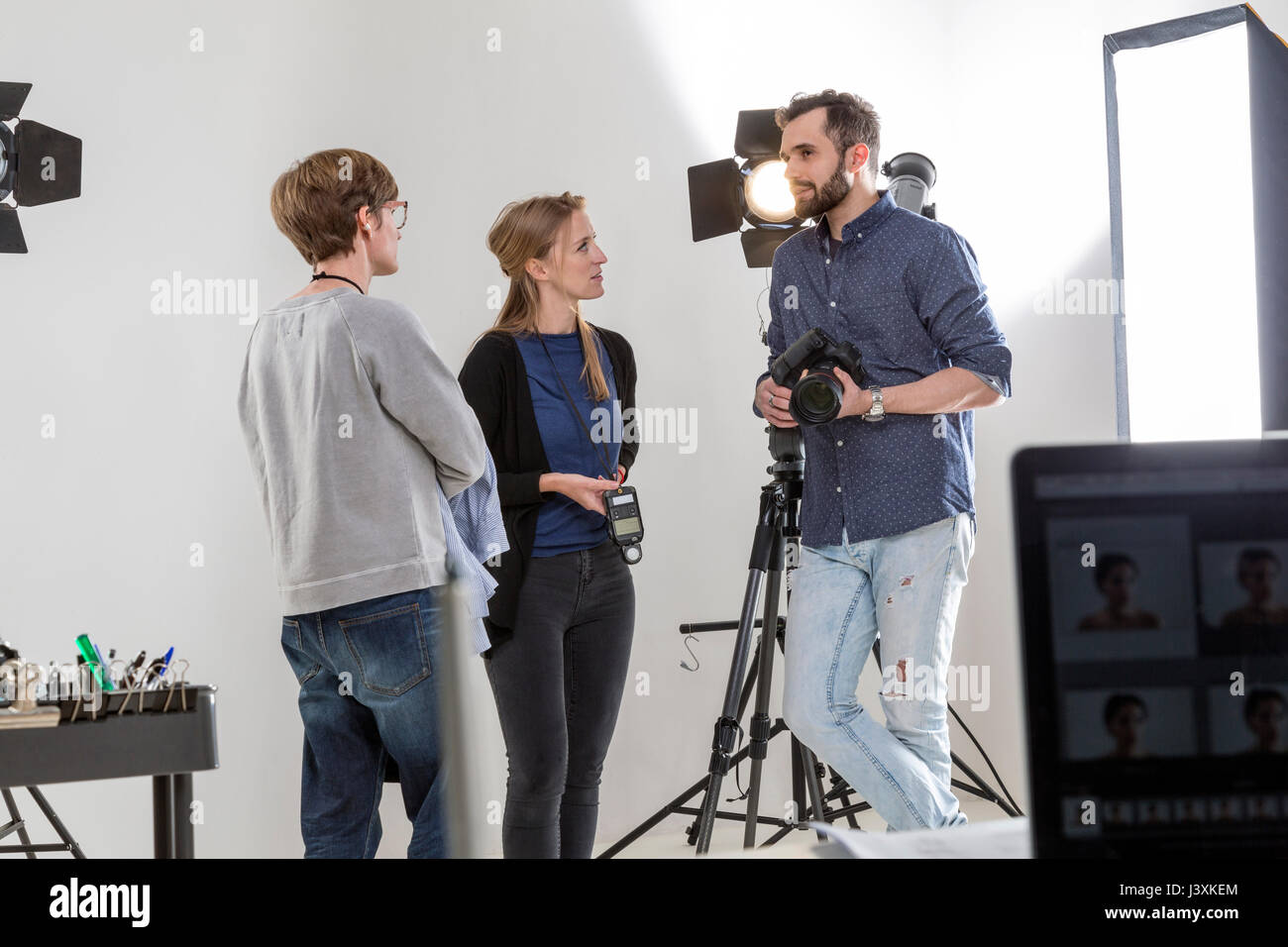 Stylists and photographer talking in photography studio Stock Photo - Alamy