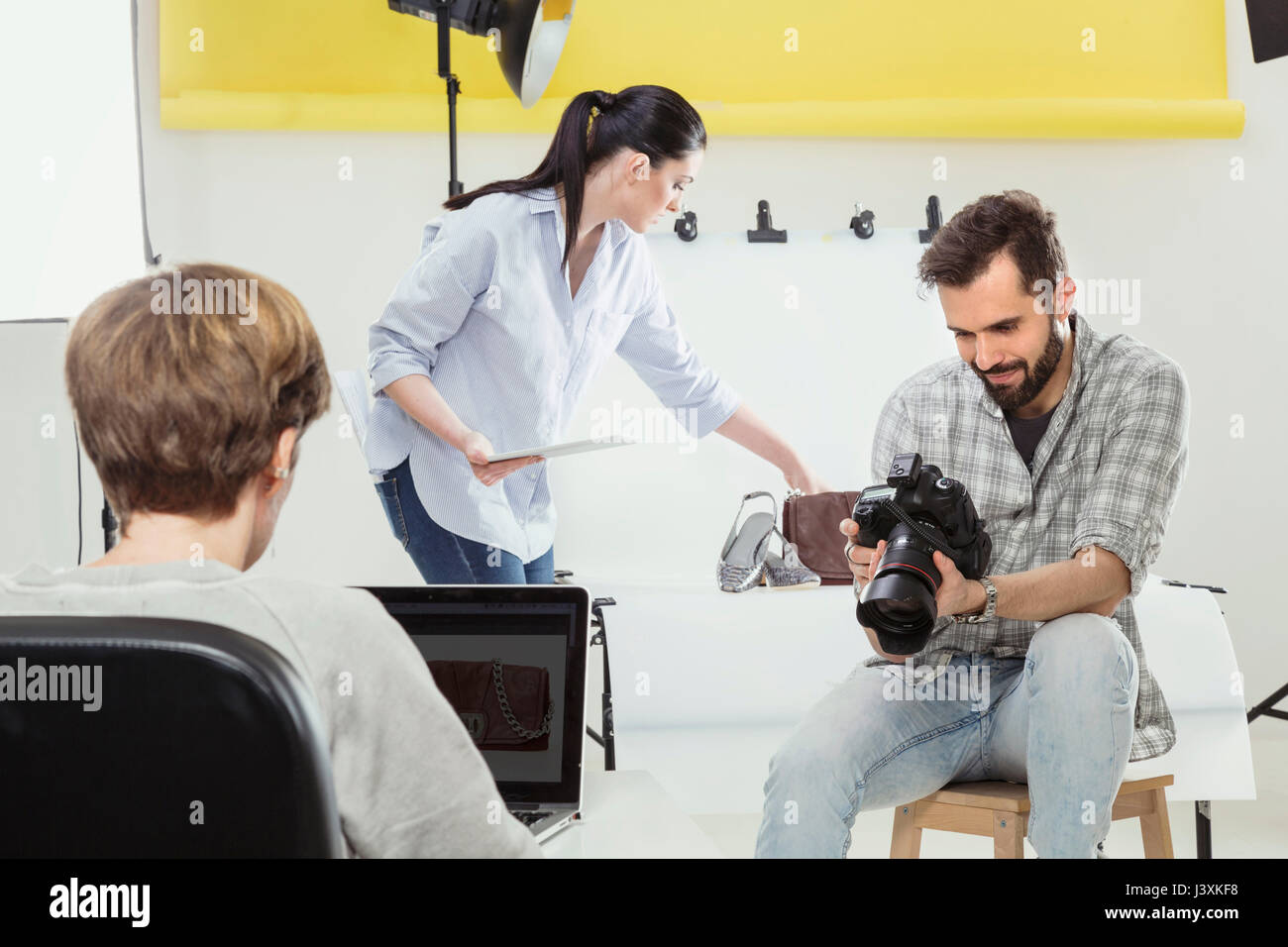 Stylists and photographer in photography studio Stock Photo - Alamy