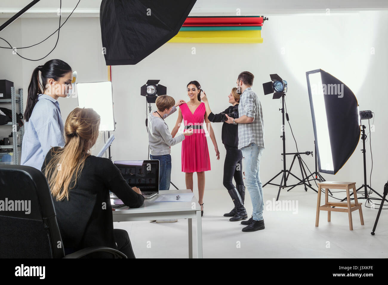 Stylists styling model in photography studio shoot Stock Photo - Alamy