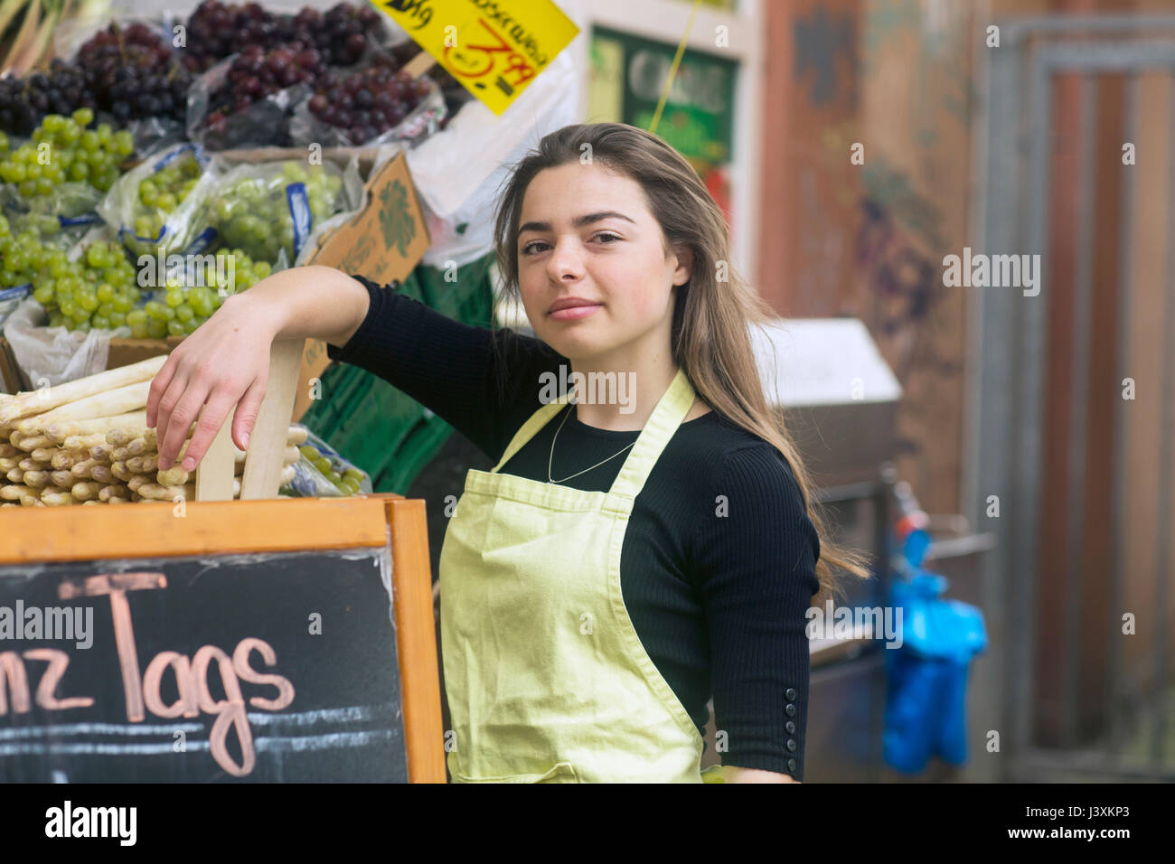 Portrait of young female fruit and veg stall trader Stock Photo - Alamy