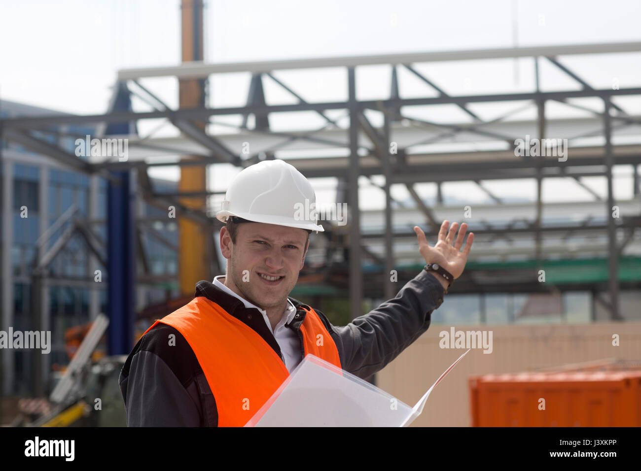 Portrait of young male civil engineer showing construction frame on ...