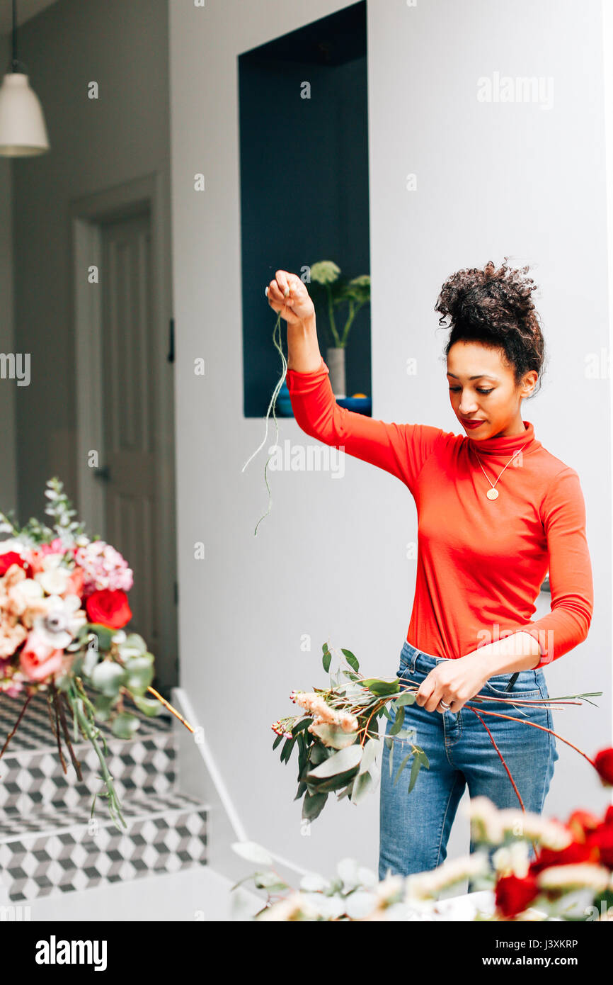 Female florist tying cut flowers in florists workshop Stock Photo - Alamy