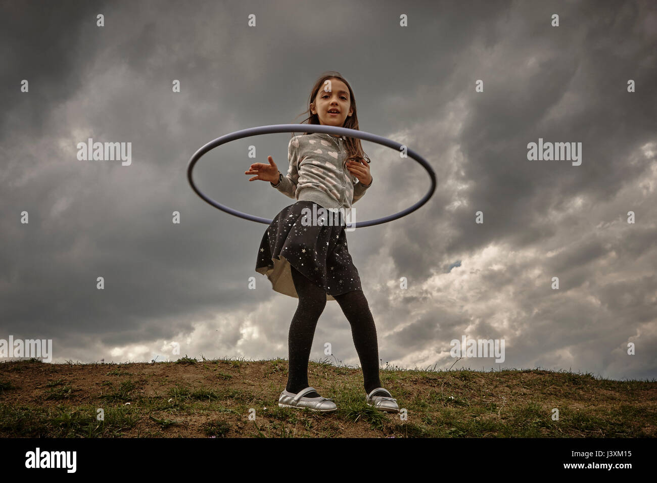 Girl playing with hoola hoop Stock Photo - Alamy