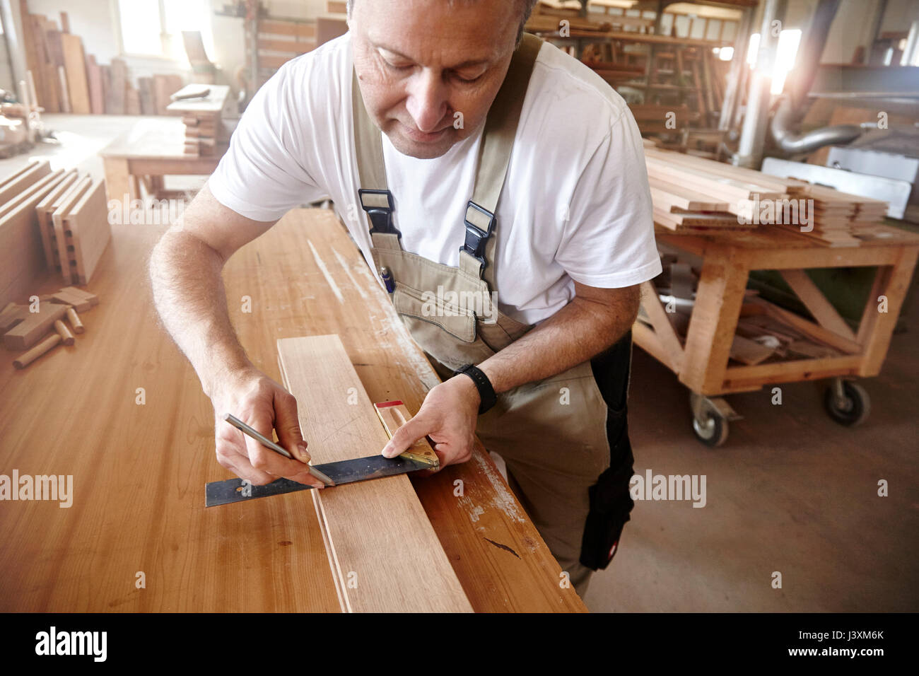 Male carpenter using set square at workbench Stock Photo - Alamy Male carpenter using set square at workbench Stock Photo - Alamy