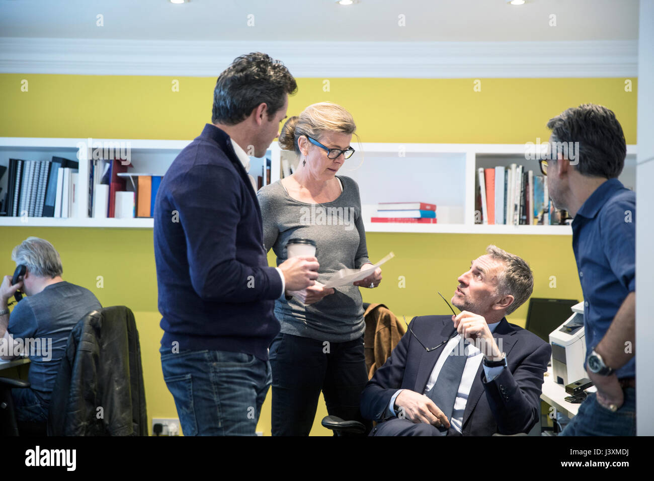 Collaborating five colleagues discussing hi-res stock photography and ...