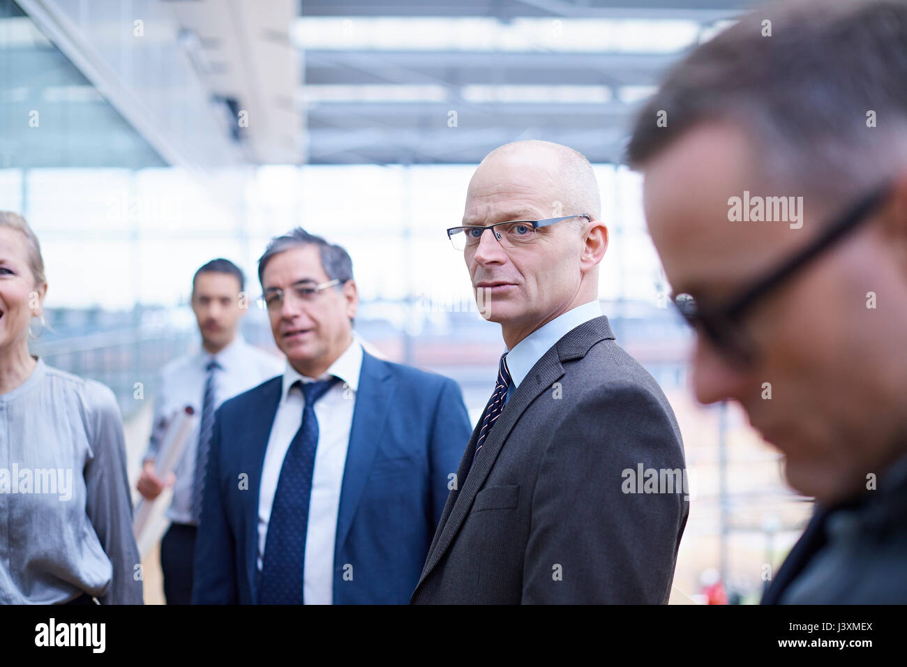 Businessman waiting for colleague on office balcony Stock Photo - Alamy