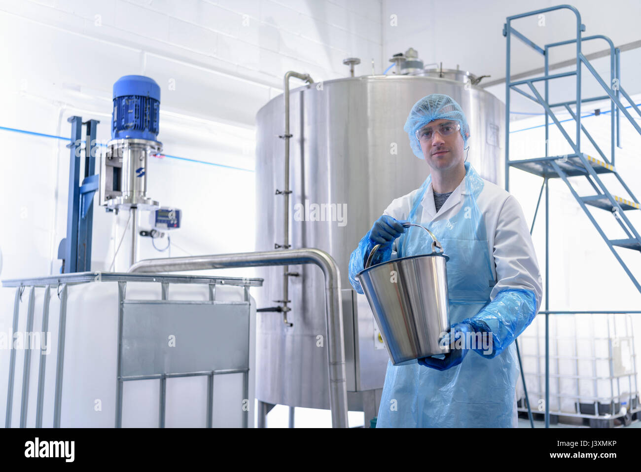 Worker using mixing plant in pharmaceutical factory Stock Photo - Alamy