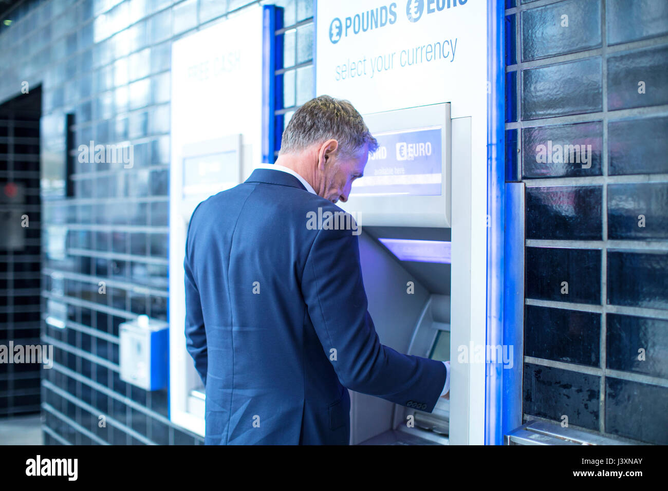 Man using cash machine Stock Photo - Alamy