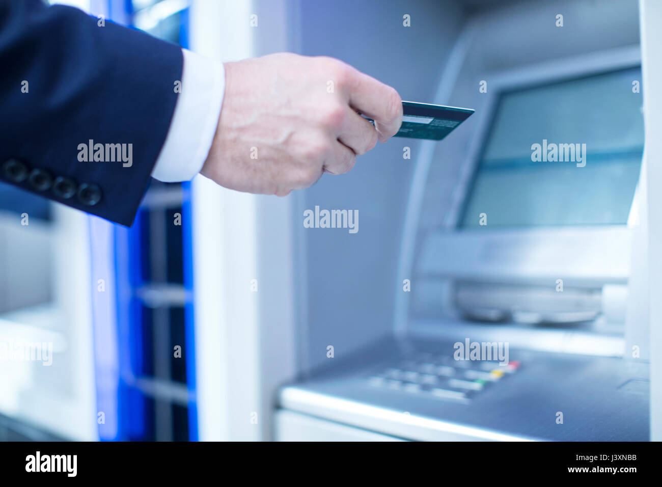Man using cash machine Stock Photo - Alamy